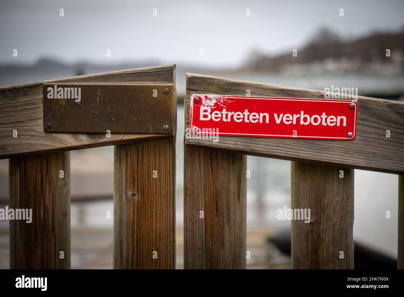 on a red sign at a gate is written in german: Betreten verboten Stock ...