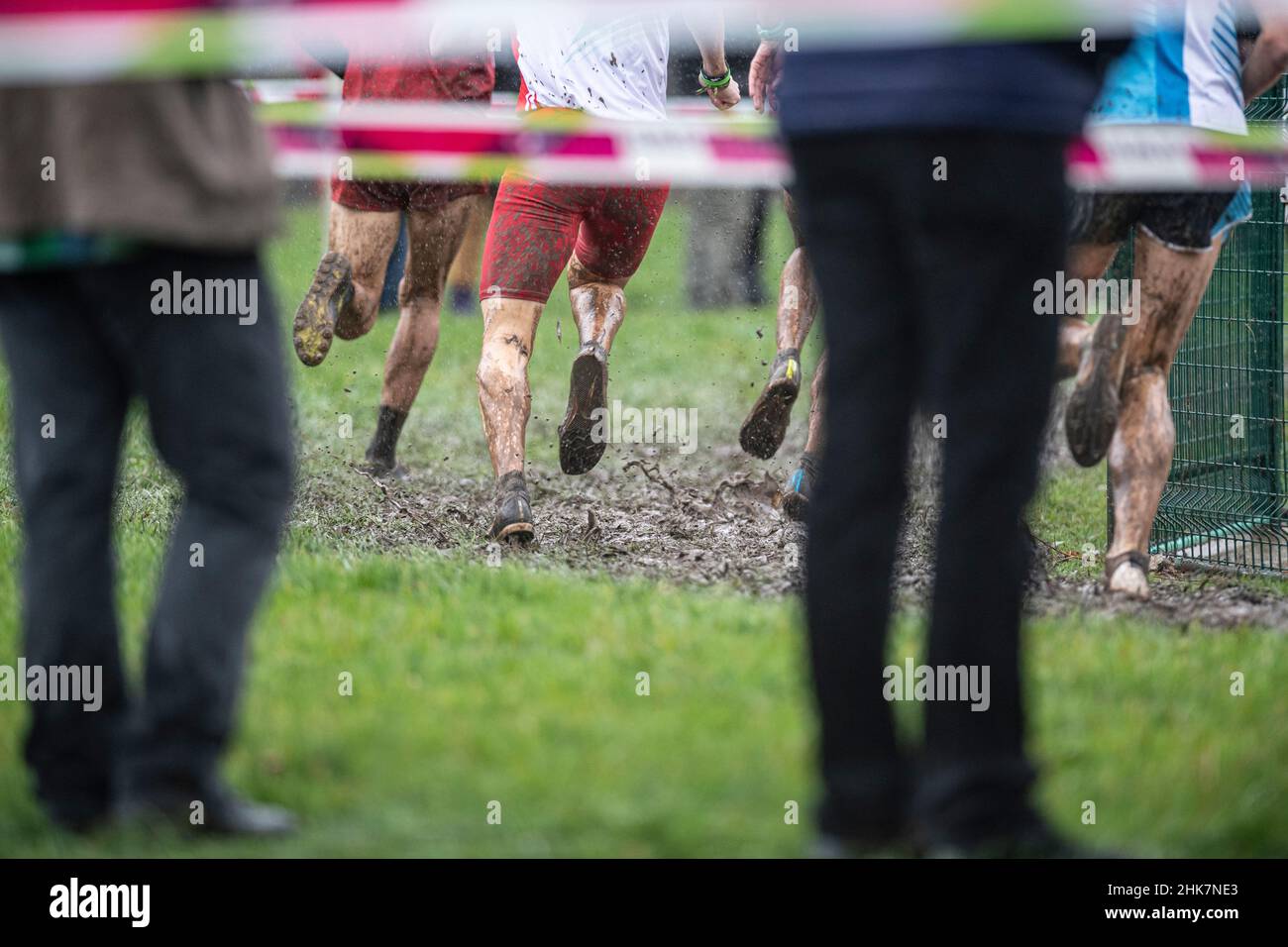 Athlete's legs running in a Cross Country between water and mud, pure ...
