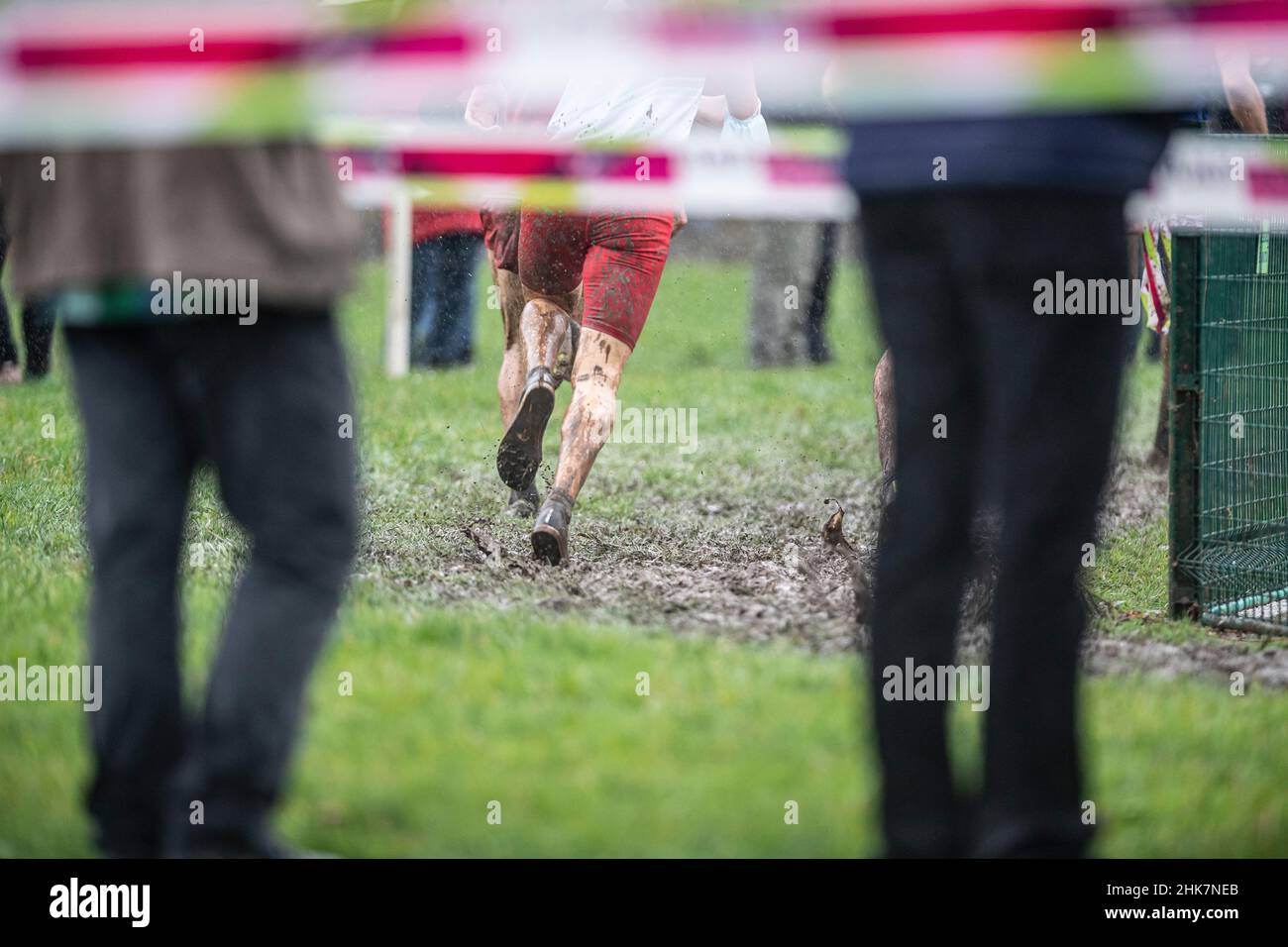 Athlete's legs running in a Cross Country between water and mud, pure ...