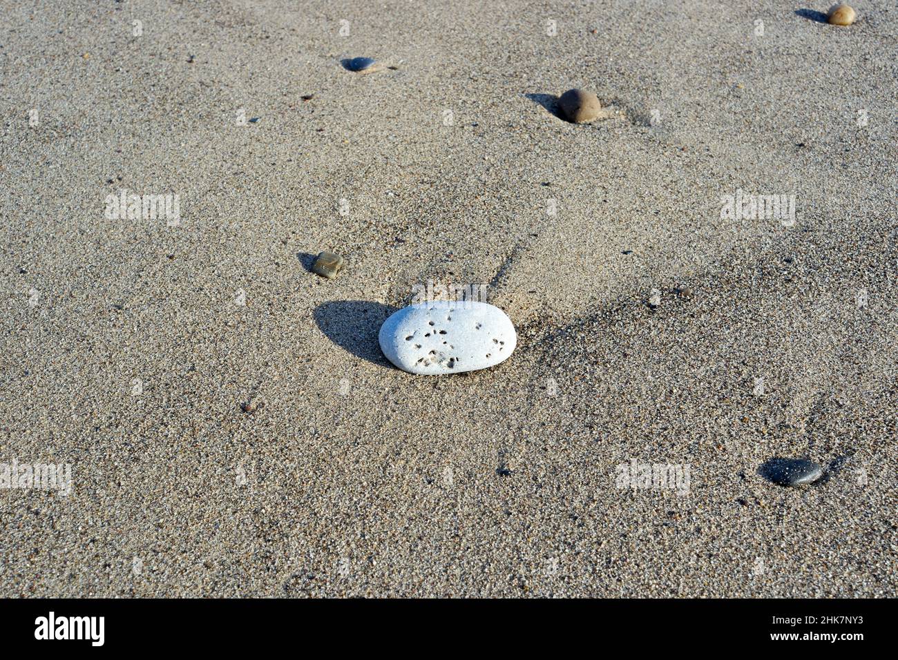 Smooth white stone washed up on a beach Stock Photo - Alamy