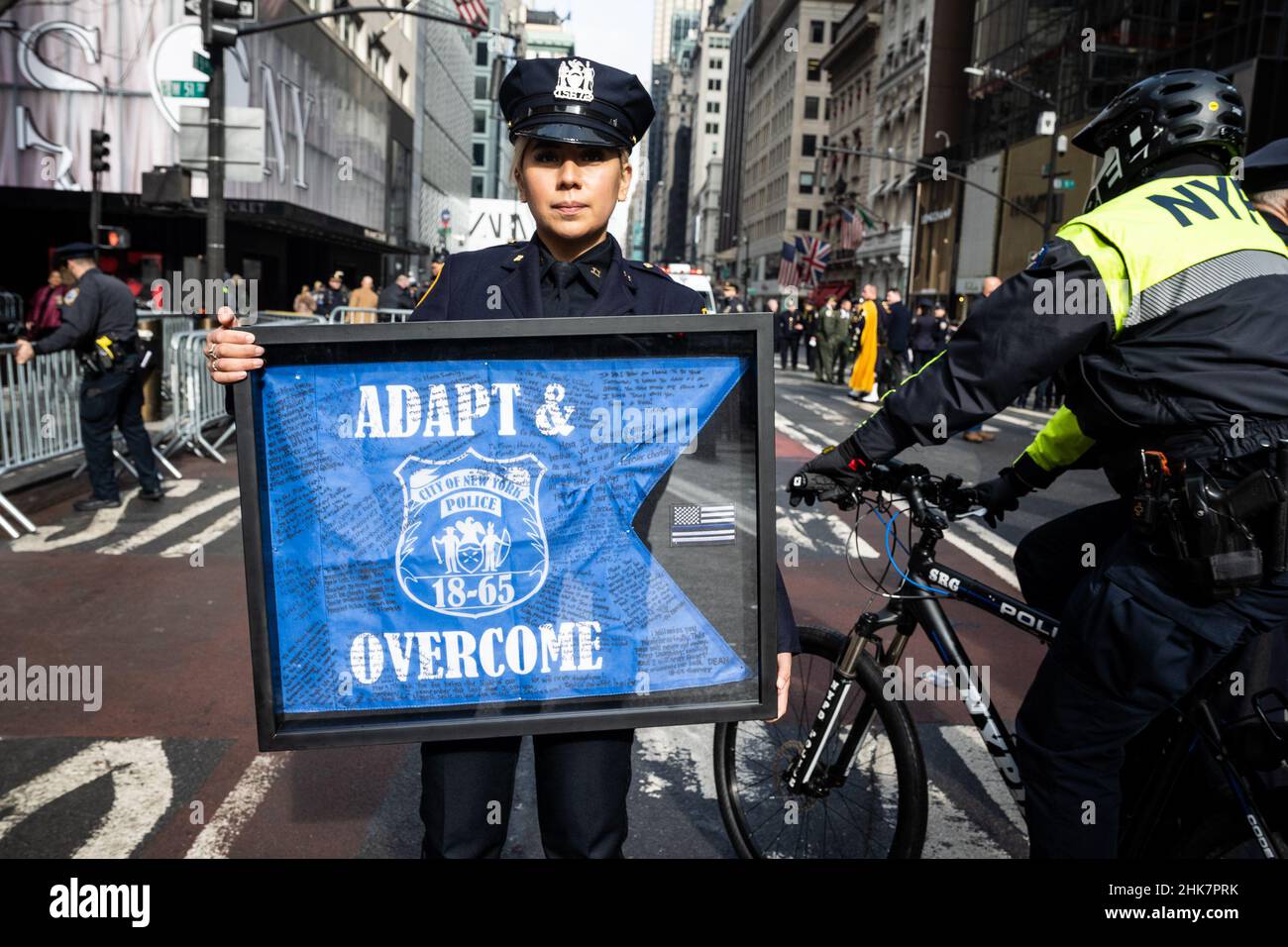 An NYPD officer holds up a sign after the funeral of fallen NYPD ...