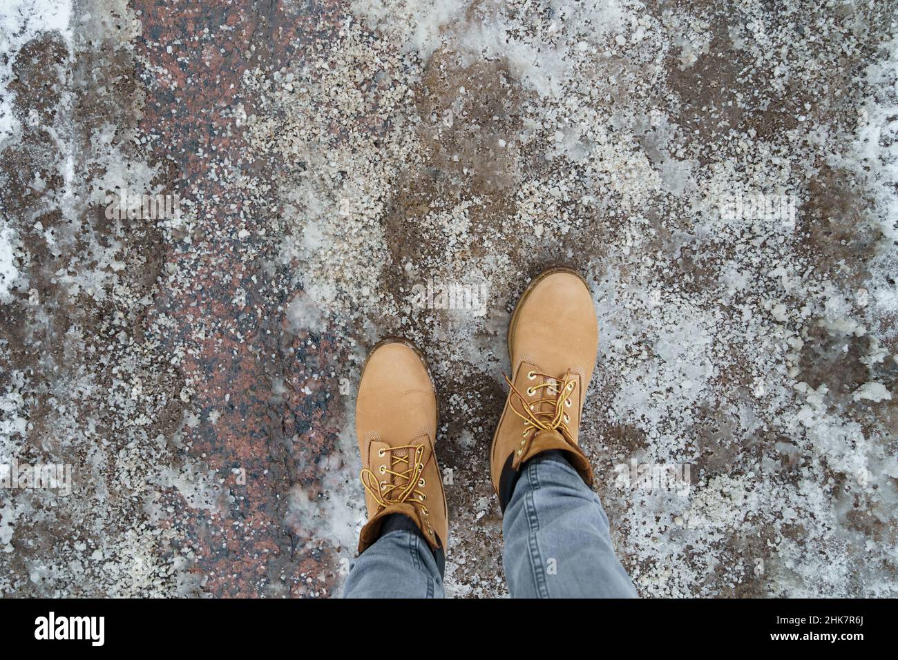 Anti-icing chemicals in winter season. Top view of winter boots and ...