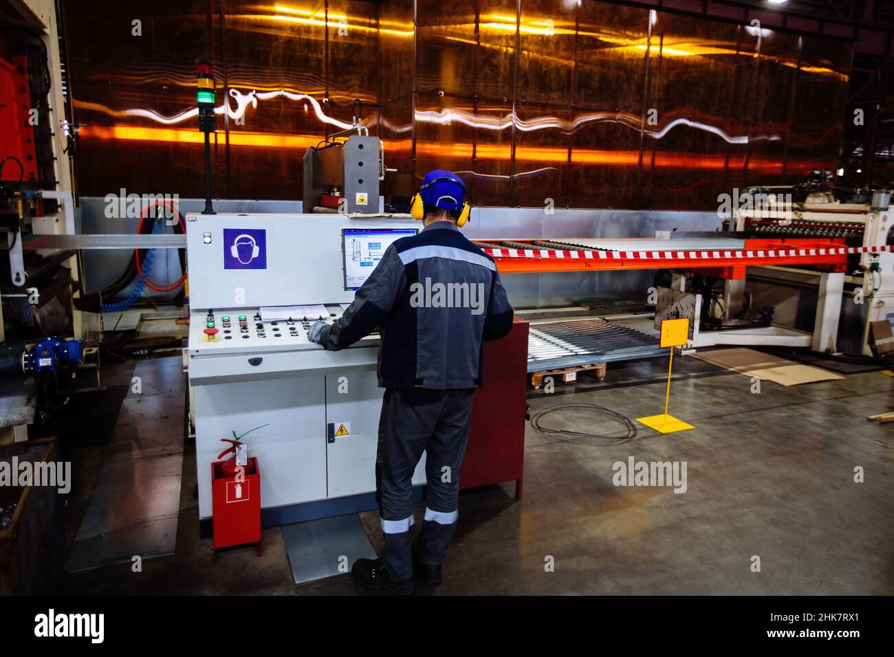 Factory worker operating CNC machine in metalworking workshop Stock ...