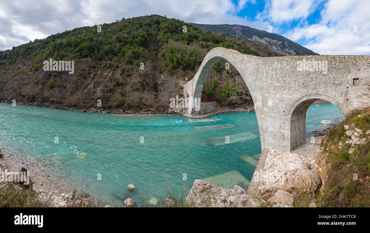The great arched stone bridge of Plaka on Arachthos river, Tzoumerka ...