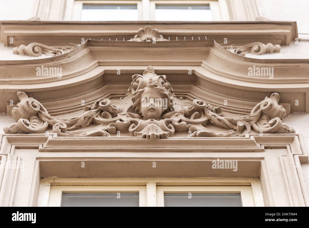 Bas-relief above the window. Bas-relief in the form of a head on one of ...