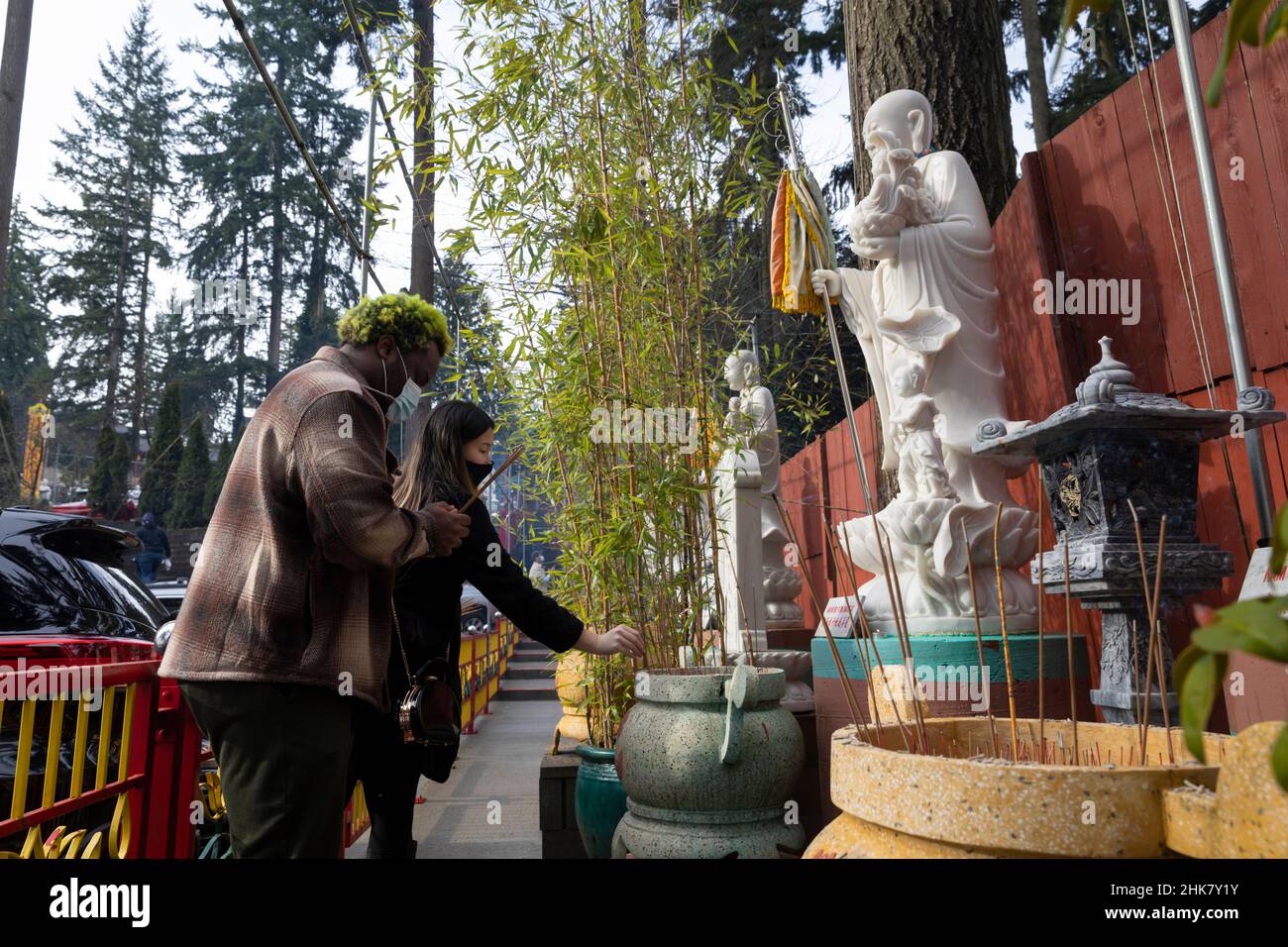 Larry Overstreet (left) and a campanion offer incense to a Buddha at ...