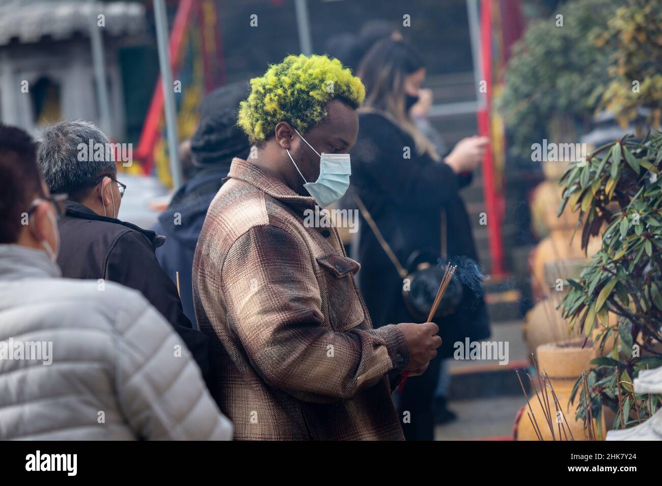 Larry Overstreet (center) offers incense to a Buddha at the Lunar New ...
