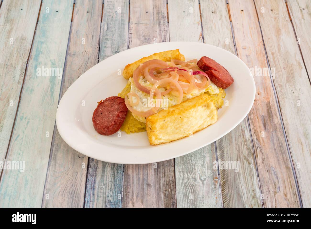 Dominican food plate with sausage, yucca, fried egg and rice Stock ...