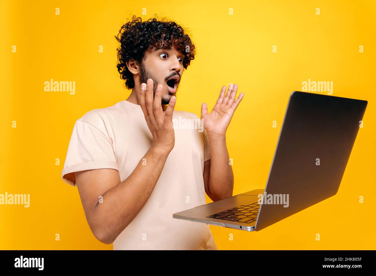 Shocked Amazed Indian Or Arabic Curly Haired Guy Looking In Surprise