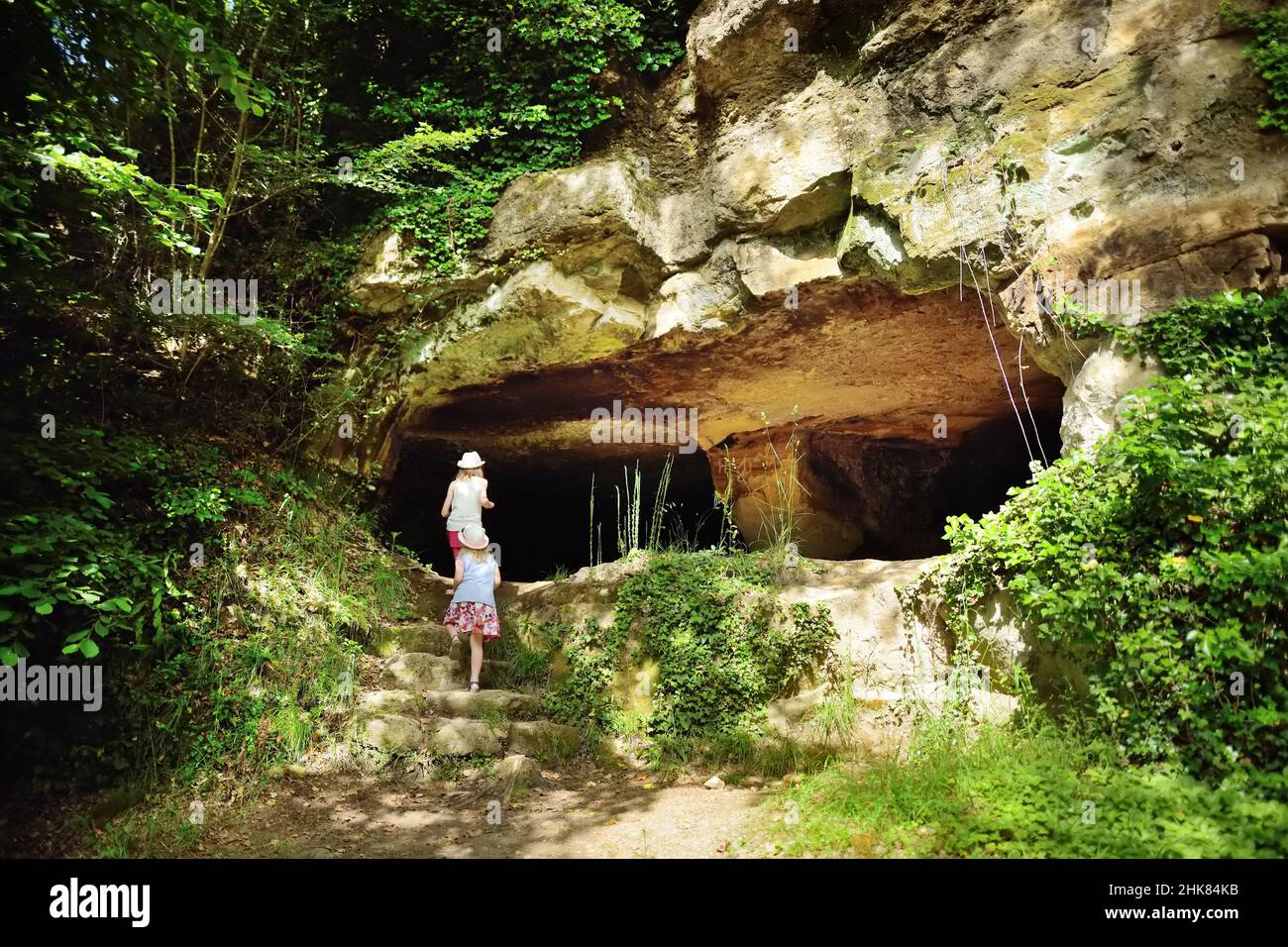 Two kids exploring old caves dug into the tuff rock and used for human ...