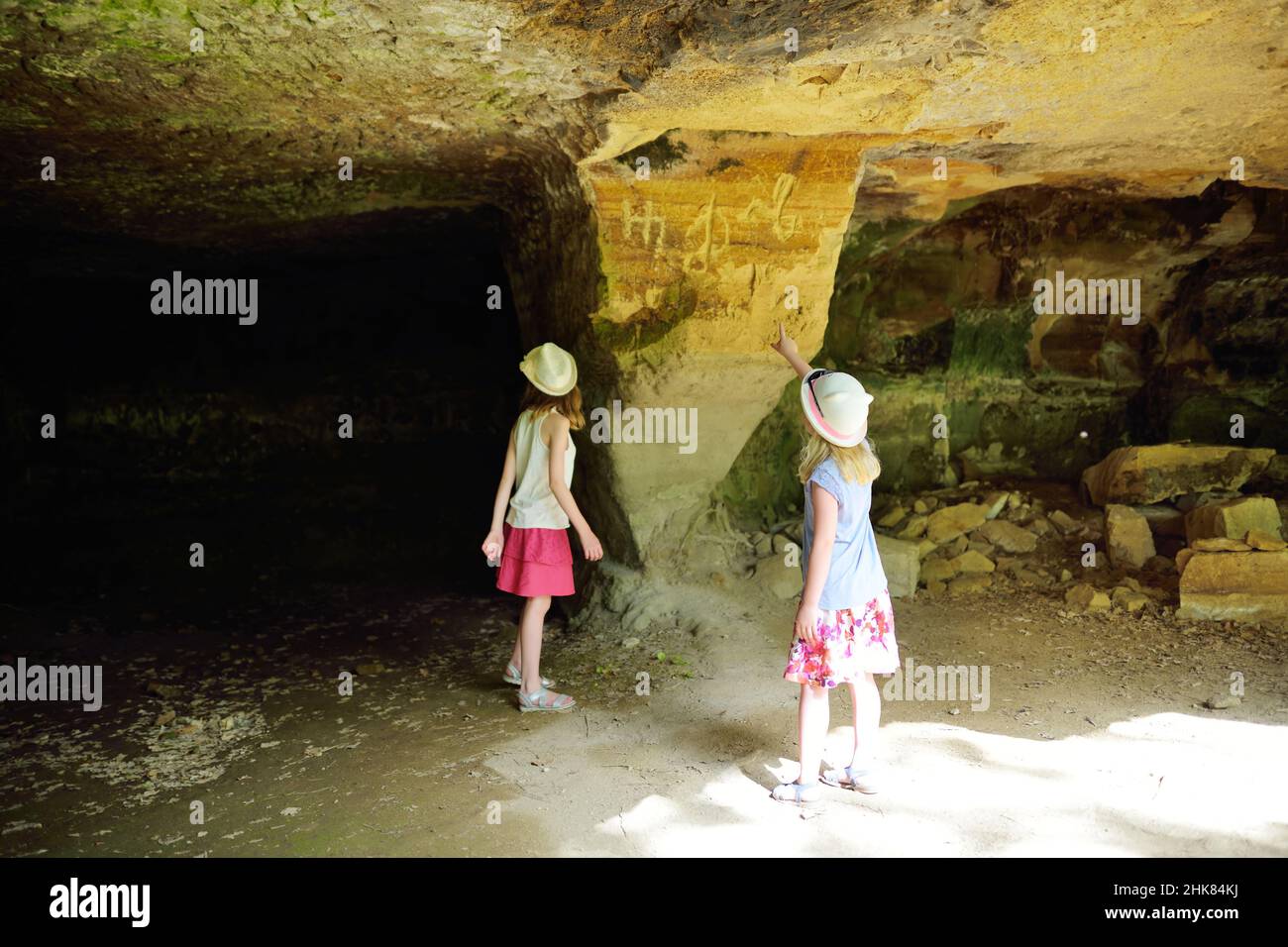 Two kids exploring old caves dug into the tuff rock and used for human ...