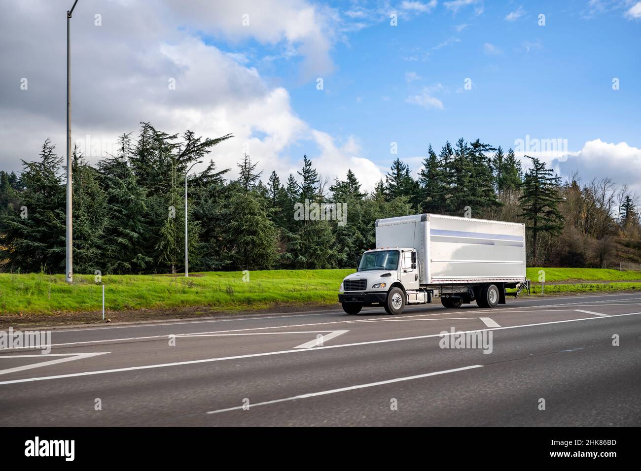 Powerful classic white big rig semi truck tractor transporting ...