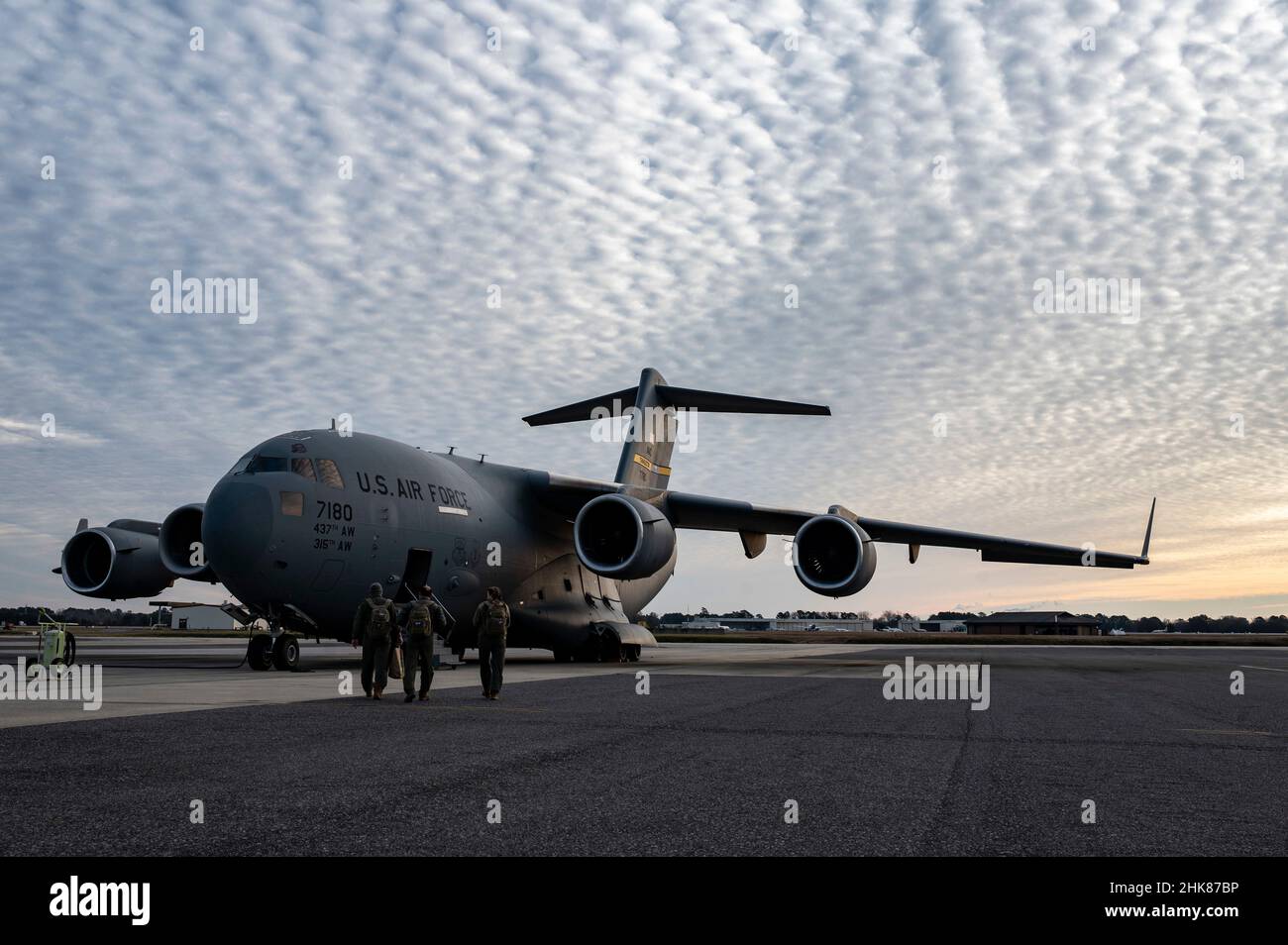 Three U.S Air Force pilots assigned to the 317th Airlift Squadron walk ...