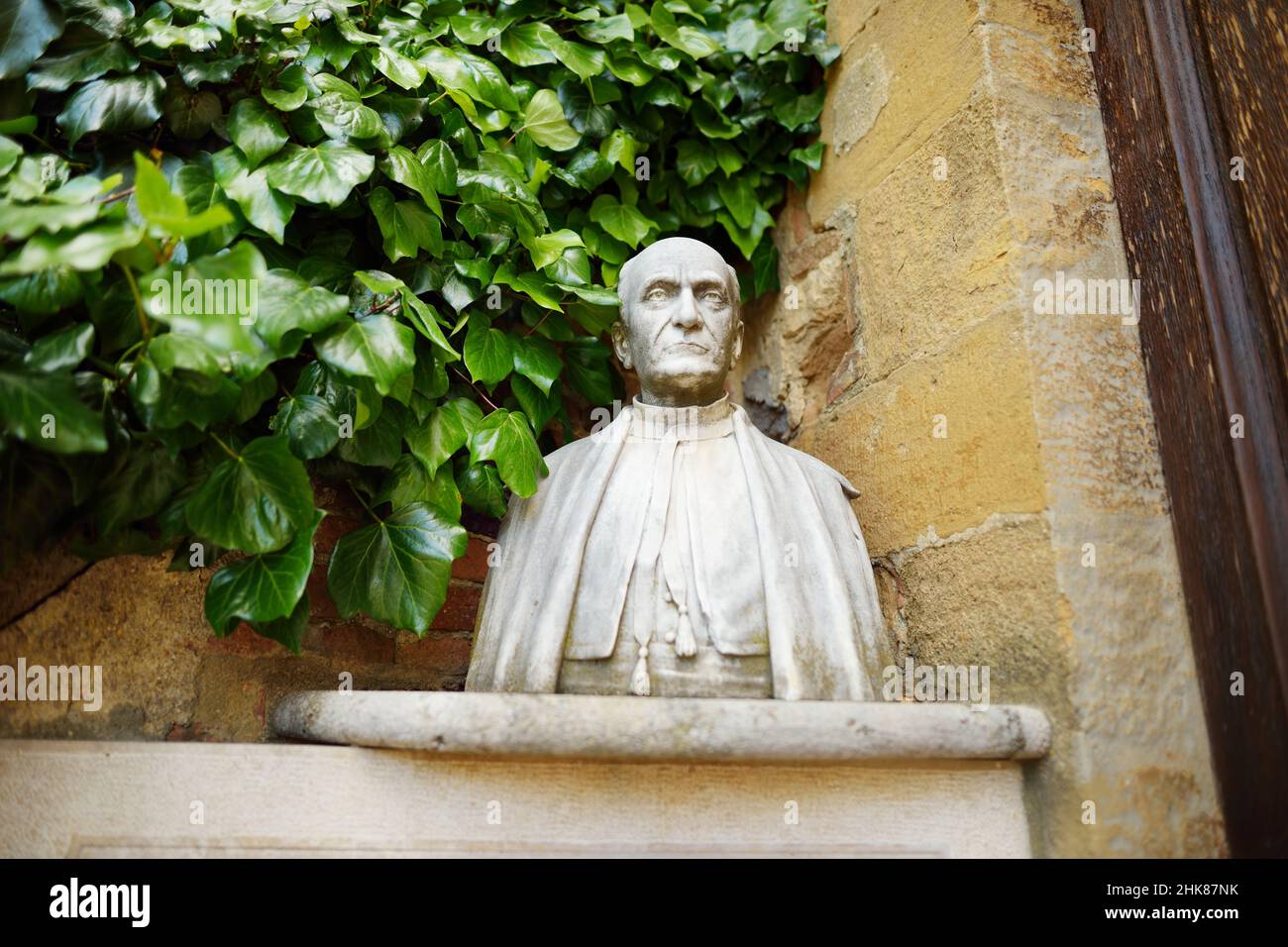 Bust of a Catholic cardinal decorating narrow old street of ...