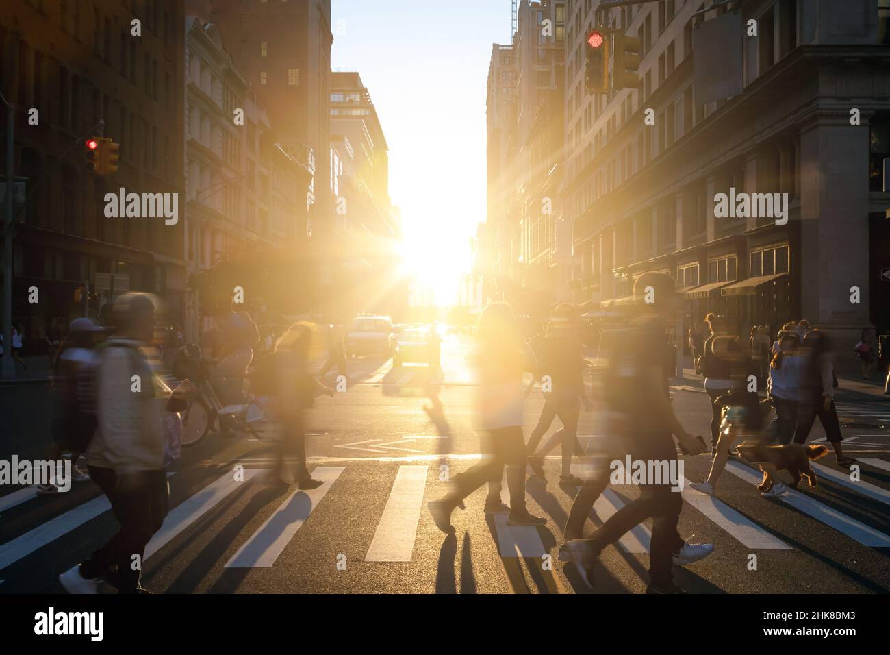 Busy intersection with crowds of people walking across the street on ...