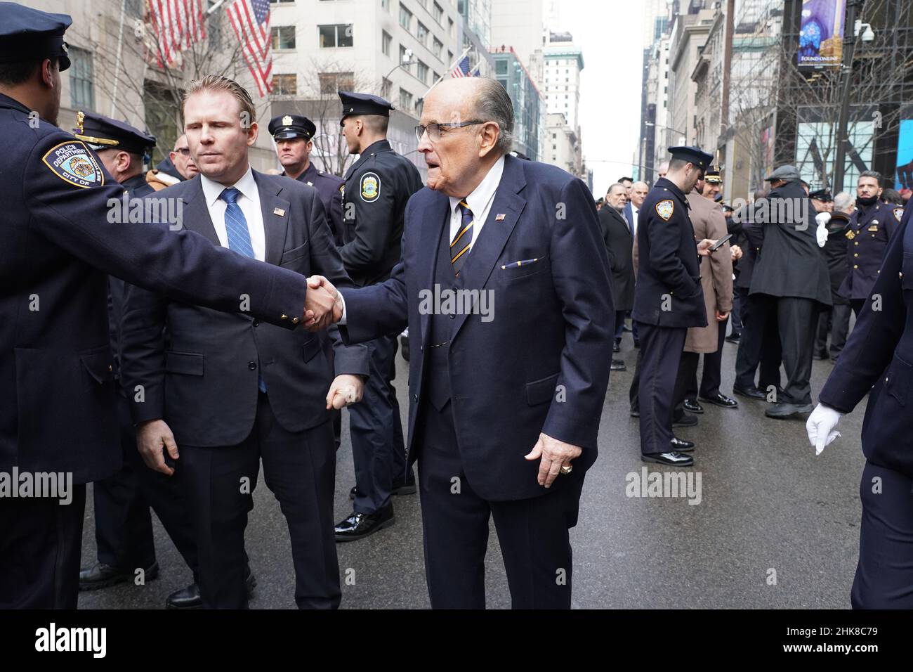 Rudy Giuliani greets a police officer outside St. Patrick's Cathedral ...