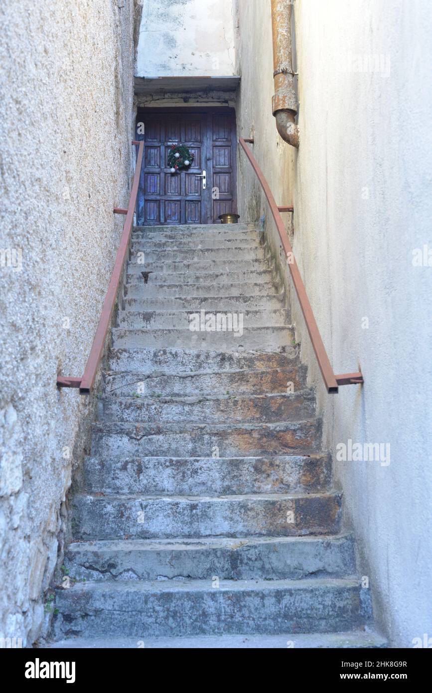 Vertical shot of stairs leading to a wooden door Stock Photo - Alamy