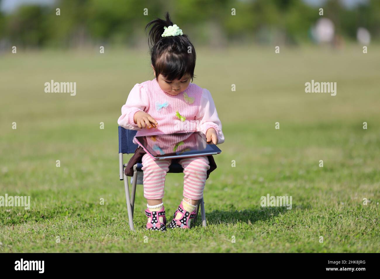 Child touching grass hi-res stock photography and images - Alamy