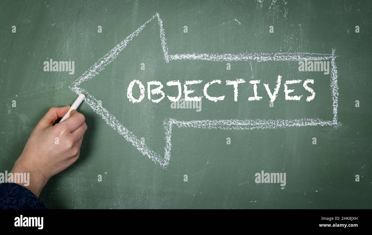 Objectives. Directional arrow drawn on a chalkboard Stock Photo - Alamy