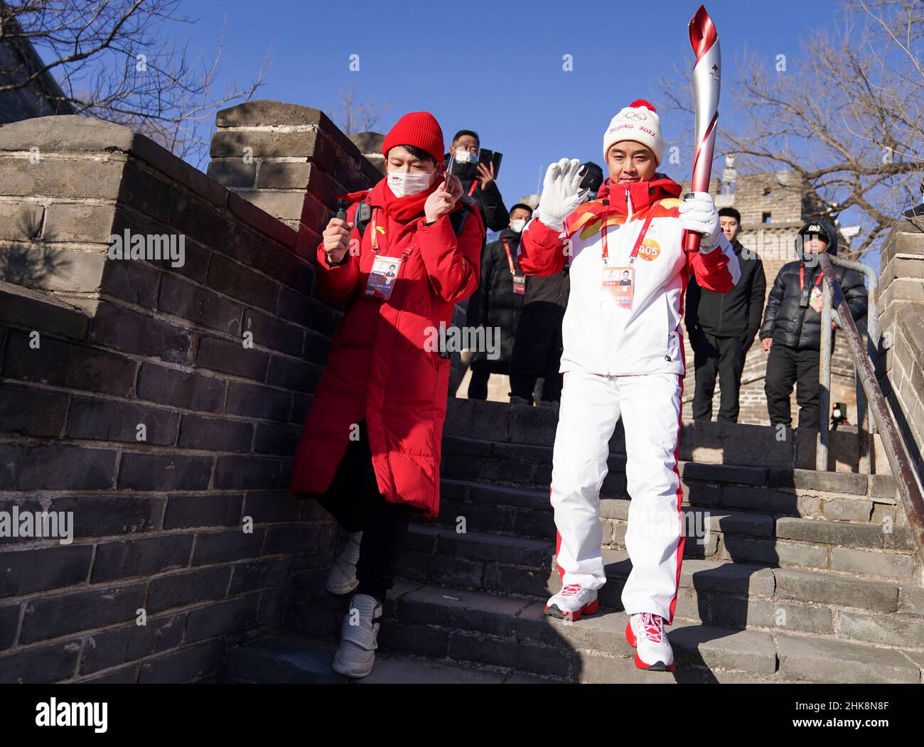 Beijing, China. 3rd Feb, 2022. Torch bearer Wang Hao ( front R) runs with the torch during the ...
