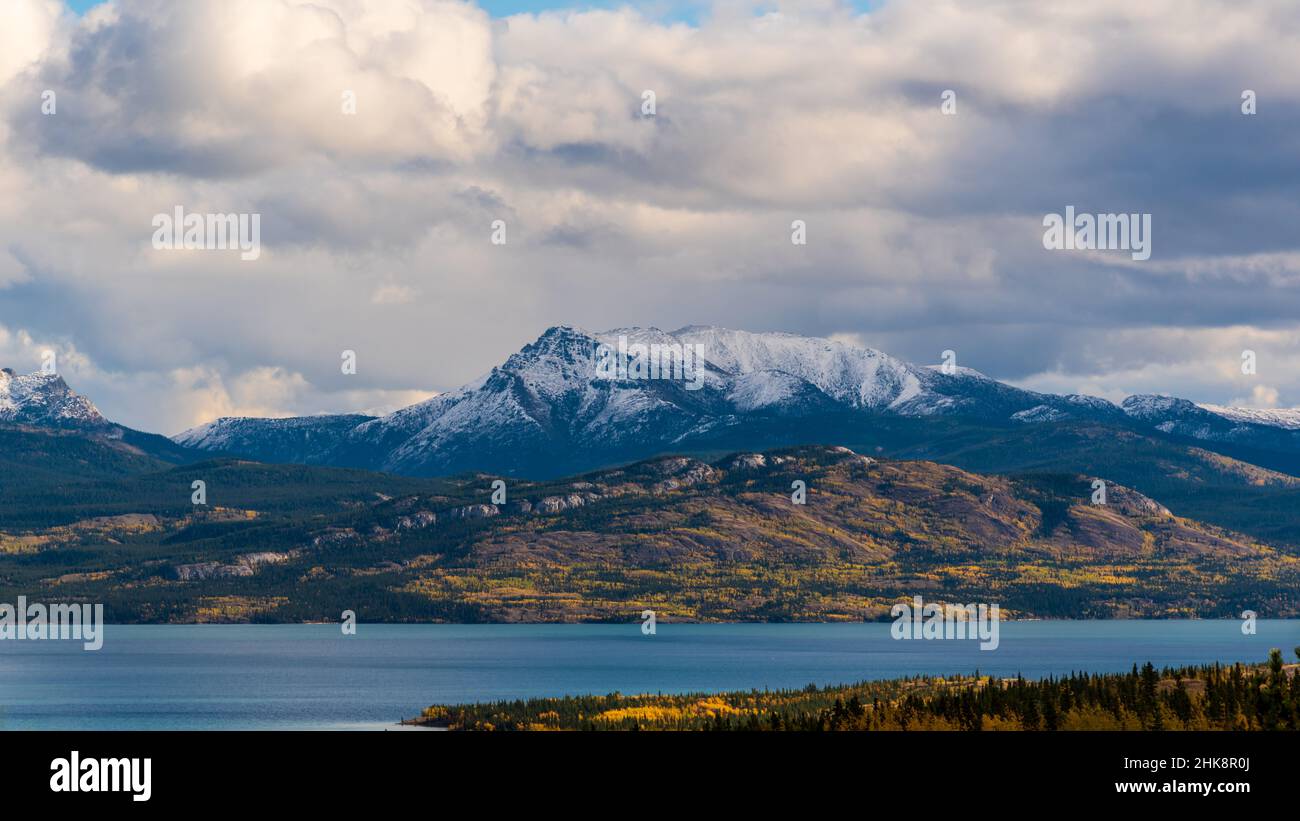 Stunning fall view at the start of winter with snow capped mountains in ...