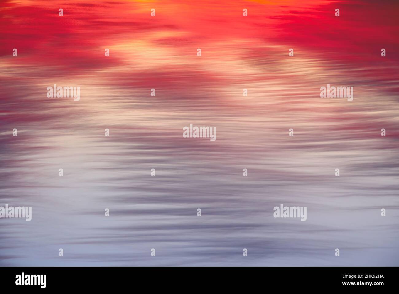 Pink wavy sky and clouds look like water with ripples. Abstract nature ...