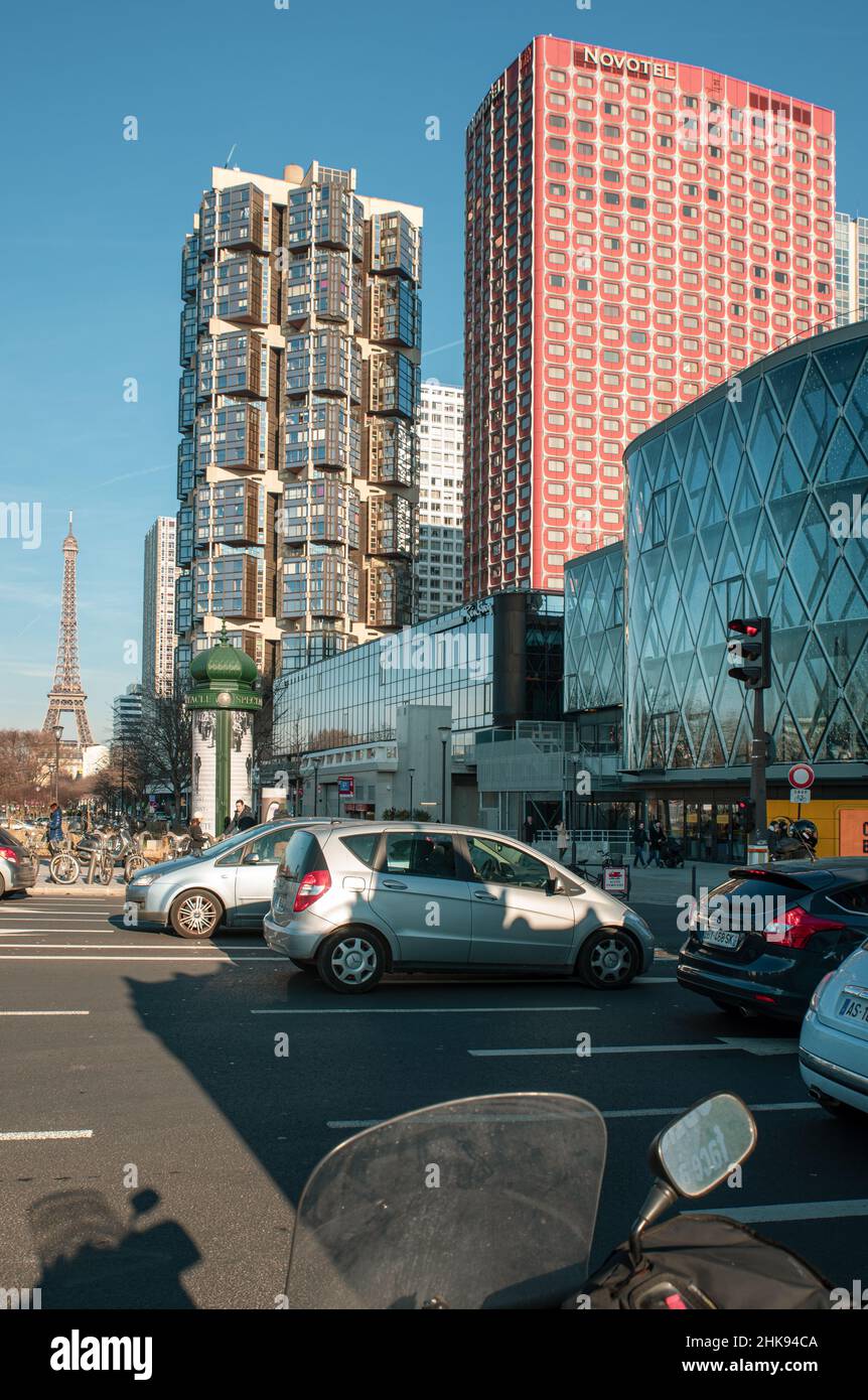 Vertical shot of creative buildings and cars in the street in Paris ...