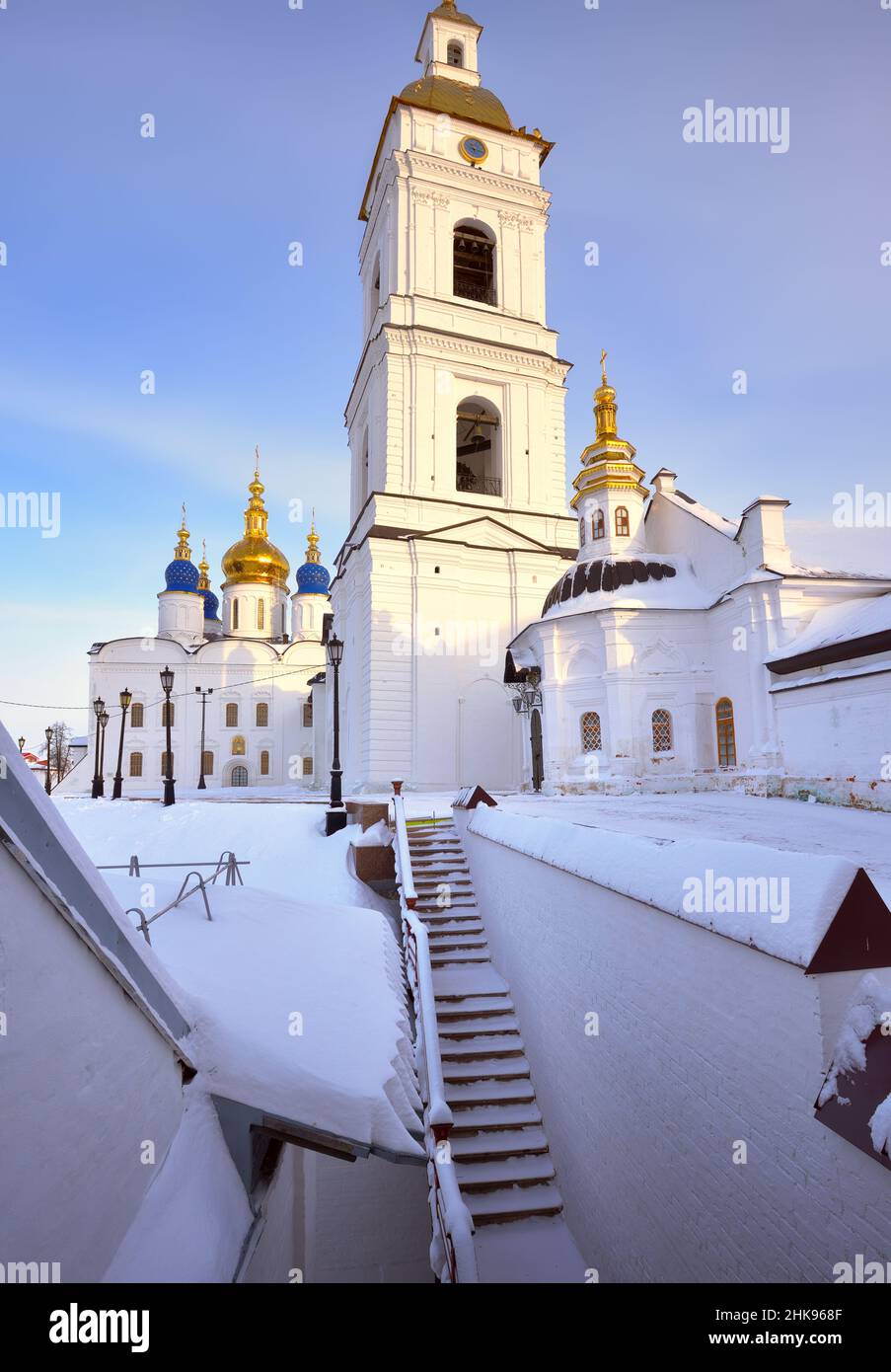 Tobolsk Kremlin in winter. The white stone wall of the high bell tower ...