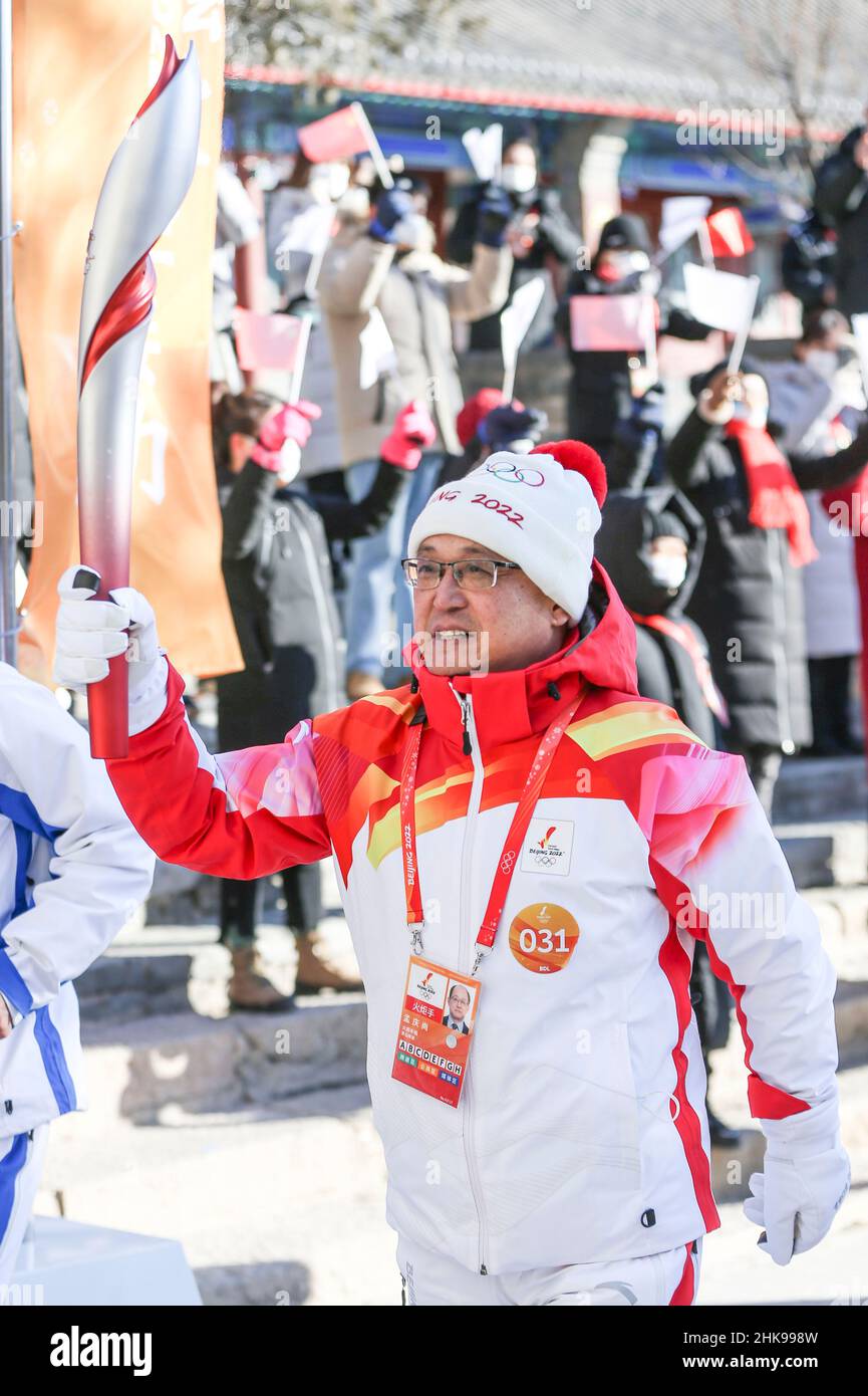Beijing, China. 3rd Feb, 2022. Torch bearer Meng Qingshang runs with the torch during the ...