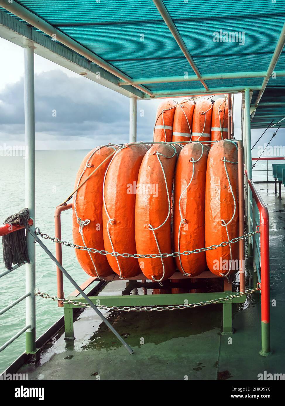 Orange inflatable lifeboats on ferry deck for emergencies and maritime ...