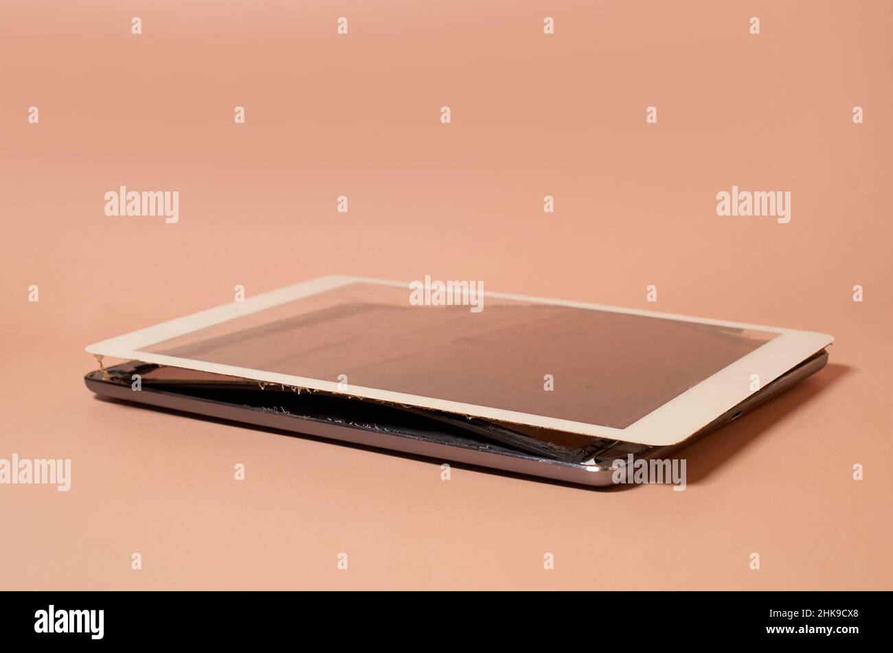 A broken tablet with a swollen battery and a dirty screen Stock Photo ...