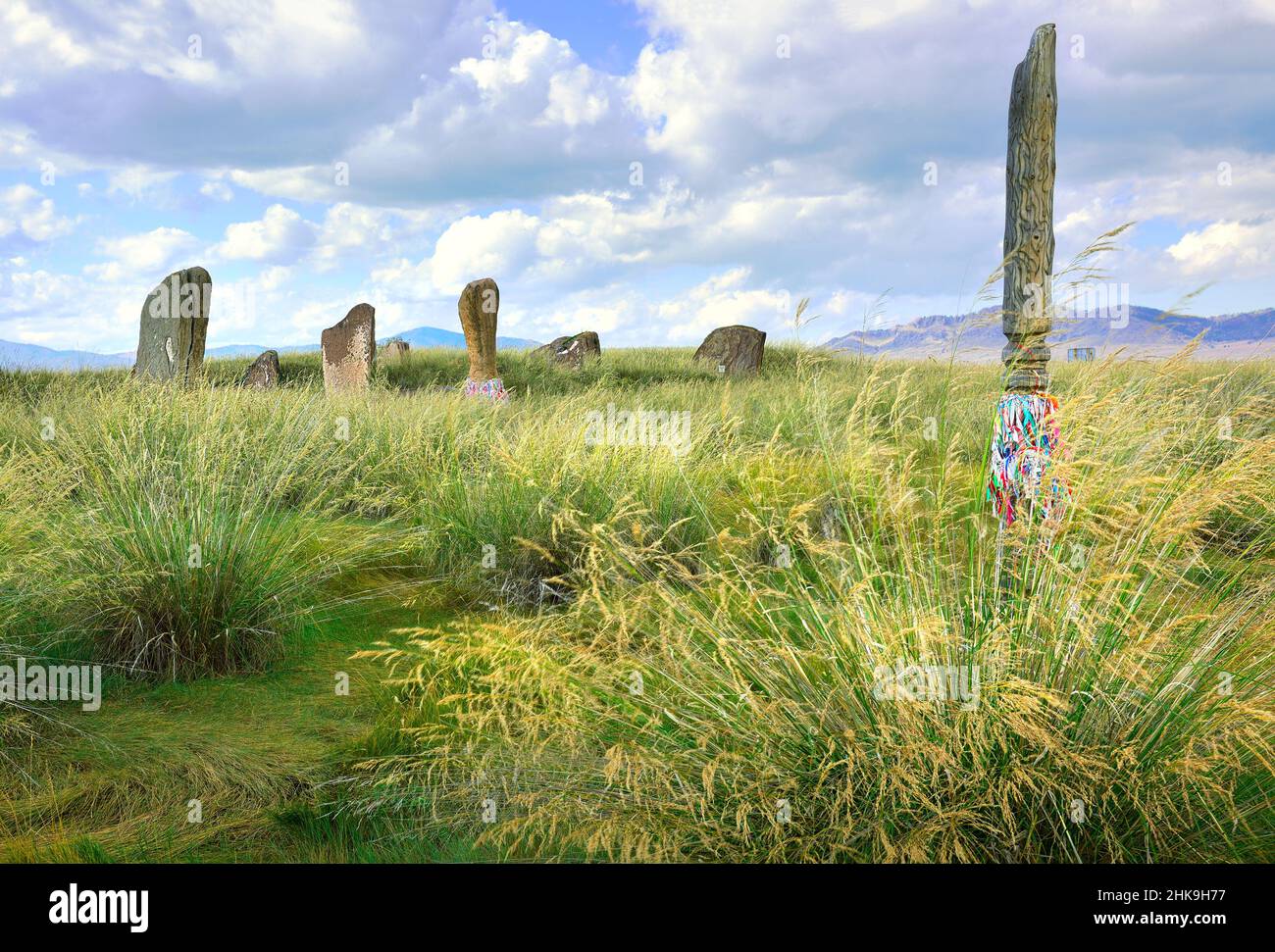 A ritual pillar on the background of stone steles of the 5th century BC ...