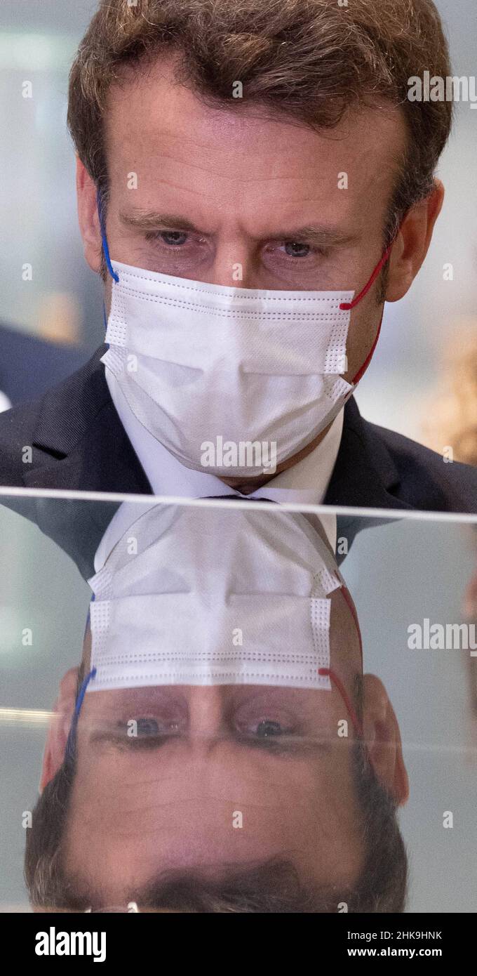 President Emmanuel Macron looks at items from ancient Egypt installed ...