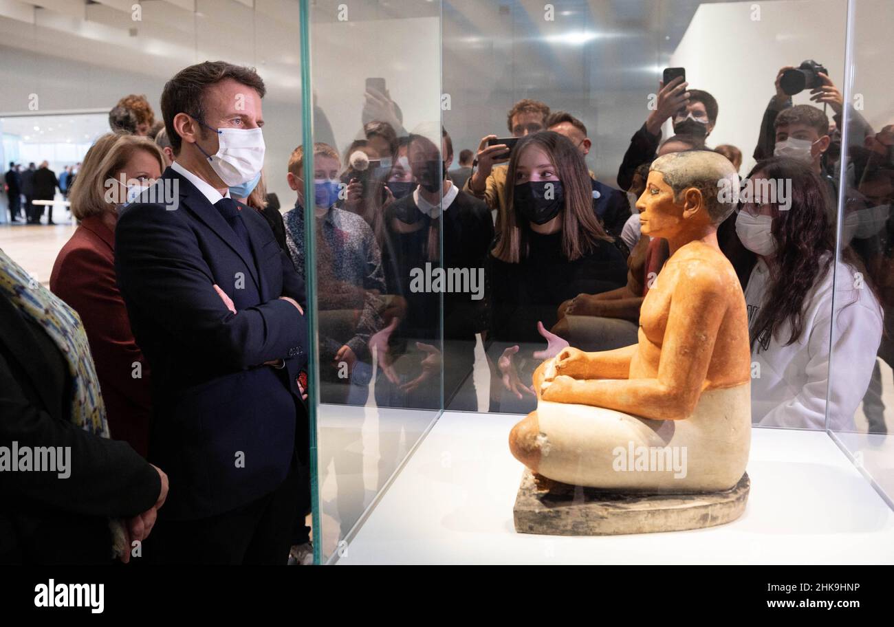 President Emmanuel Macron looks at the sculpture "Scribe Accroupi ...