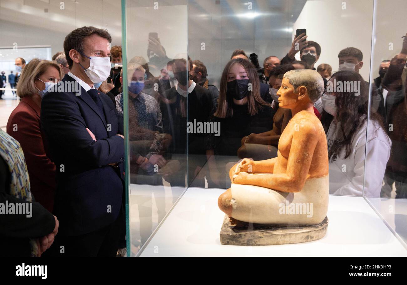President Emmanuel Macron looks at the sculpture "Scribe Accroupi ...
