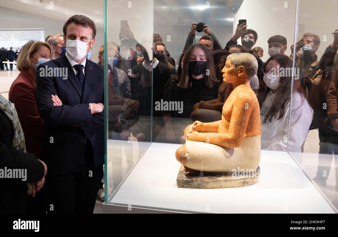 President Emmanuel Macron looks at the sculpture "Scribe Accroupi ...
