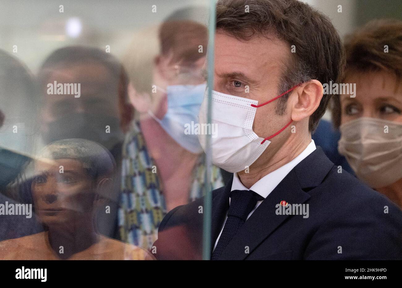 President Emmanuel Macron looks at items from ancient Egypt installed ...