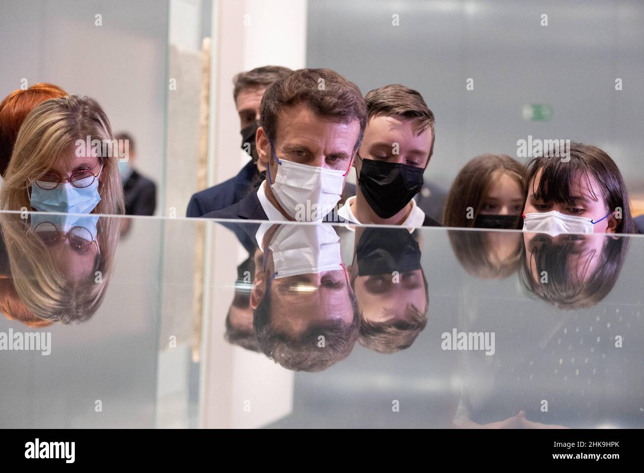 President Emmanuel Macron looks at items from ancient Egypt installed ...