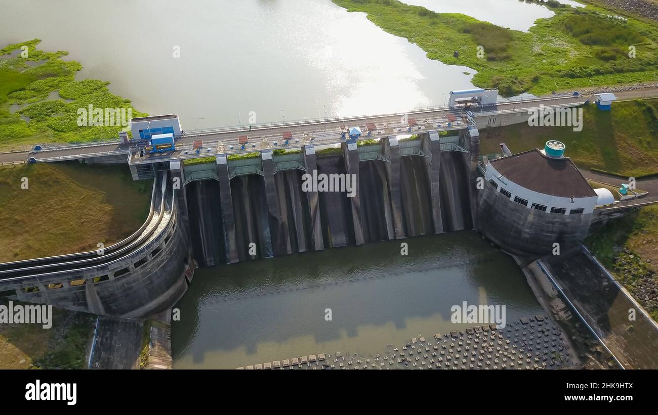 Hydroelectric dam with flowing water through gate, aerial view from ...