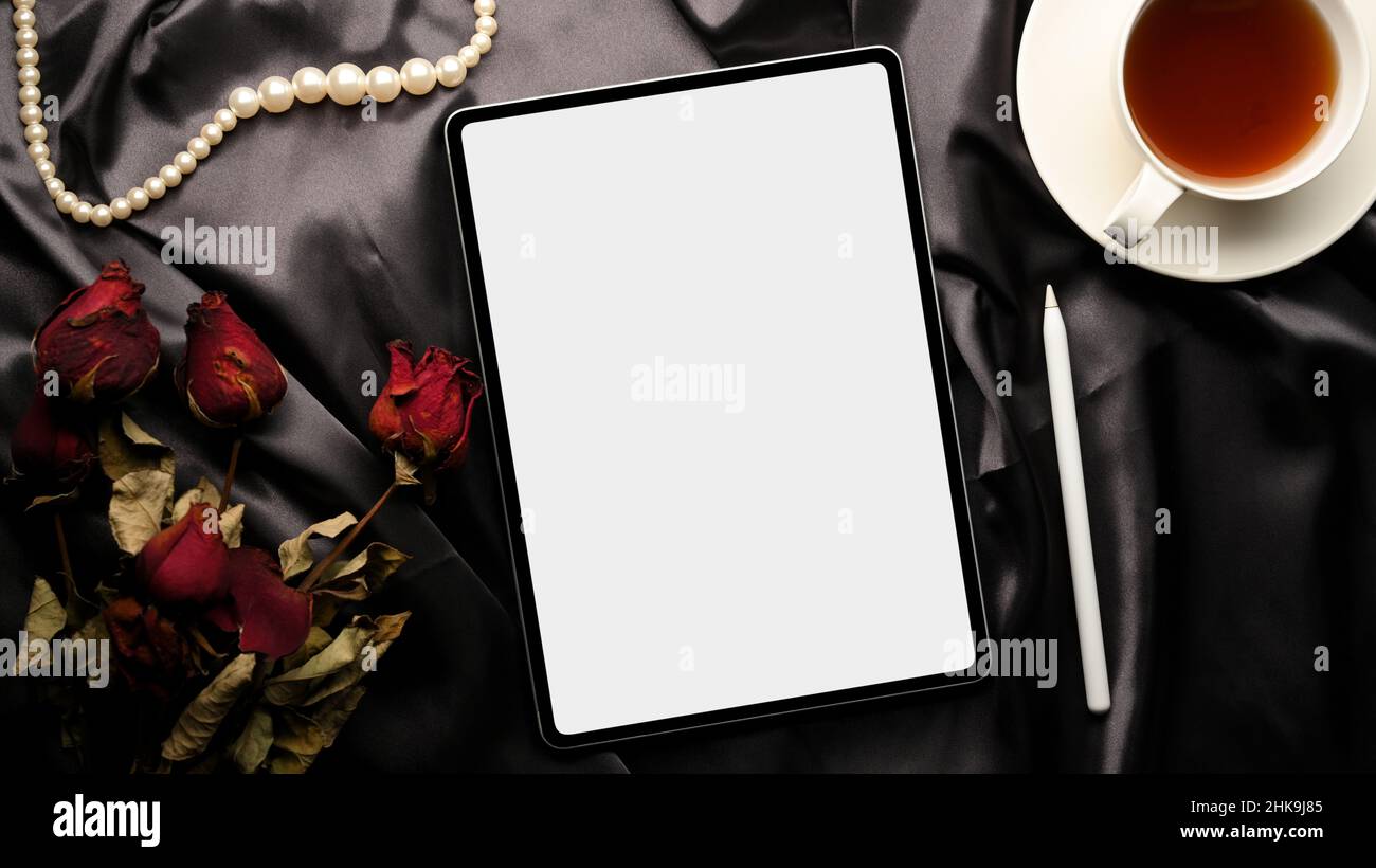 Stylish feminine black workspace with tablet touchpad white screen ...