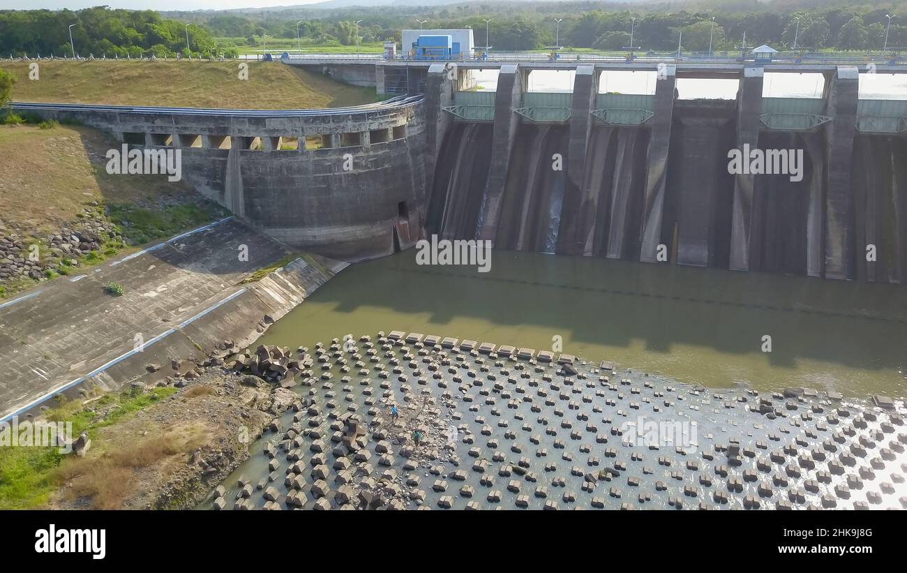 Hydroelectric dam with flowing water through gate, aerial view from ...