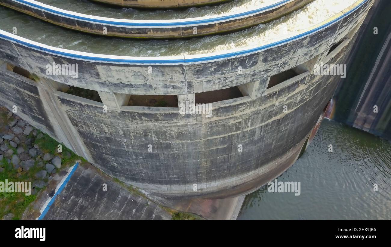 Aerial water in dam concrete spillway infrastructure at reservoir ...