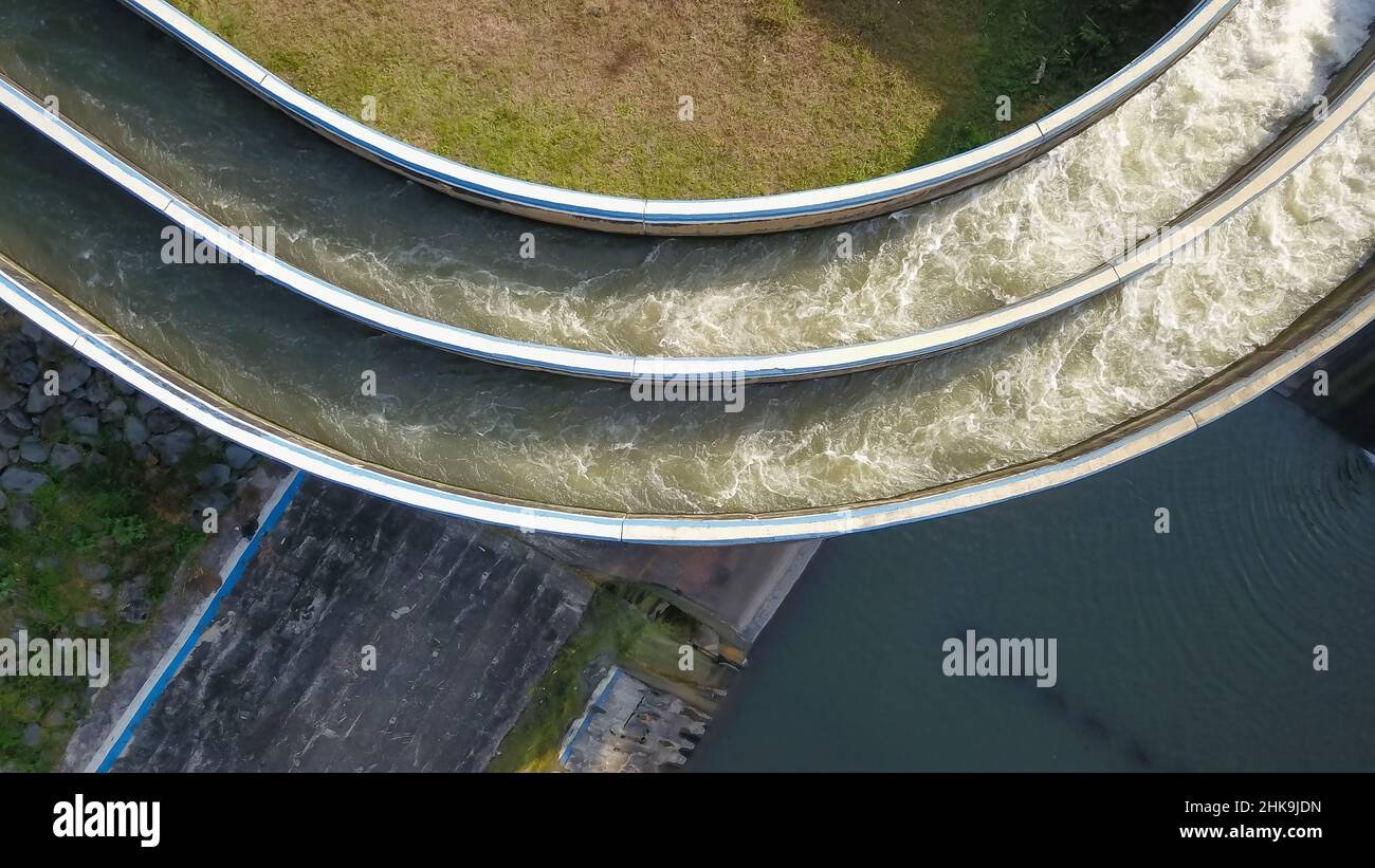 Aerial water in dam concrete spillway infrastructure at reservoir ...