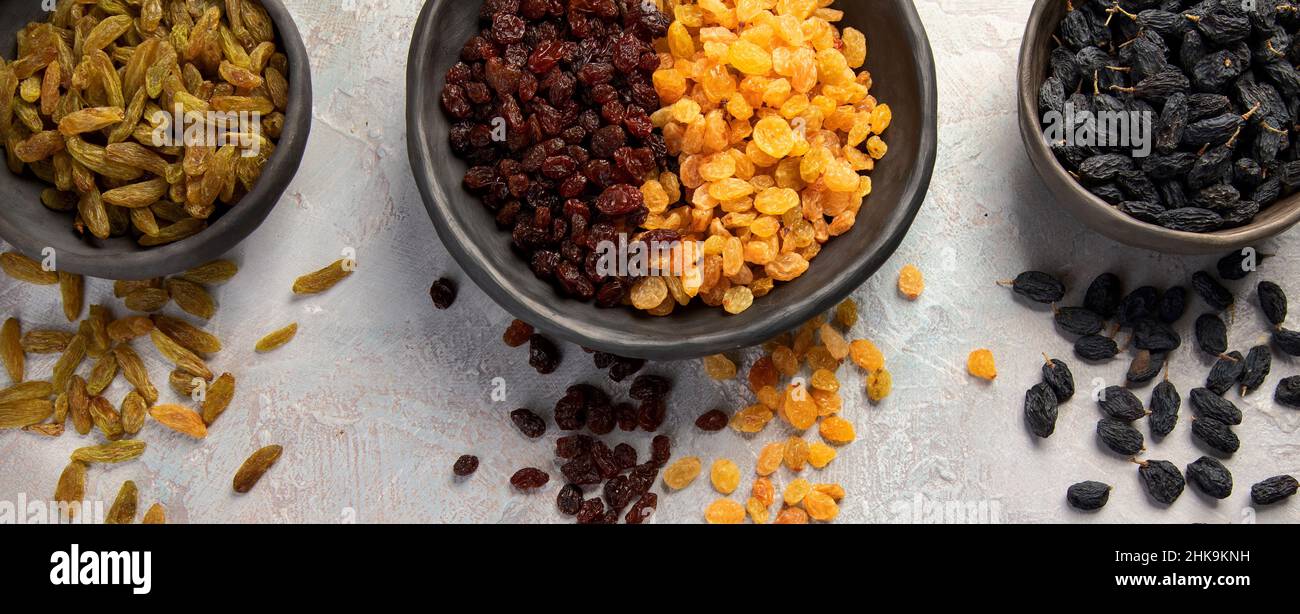 Different types of raisins on light backgroound. Dried Fruits. Top view ...
