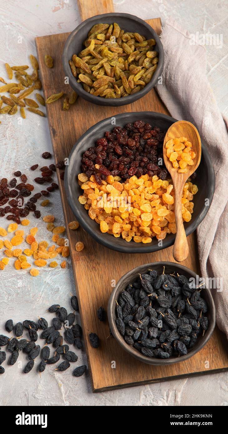 Different types of raisins on light backgroound. Dried Fruits. Top view ...