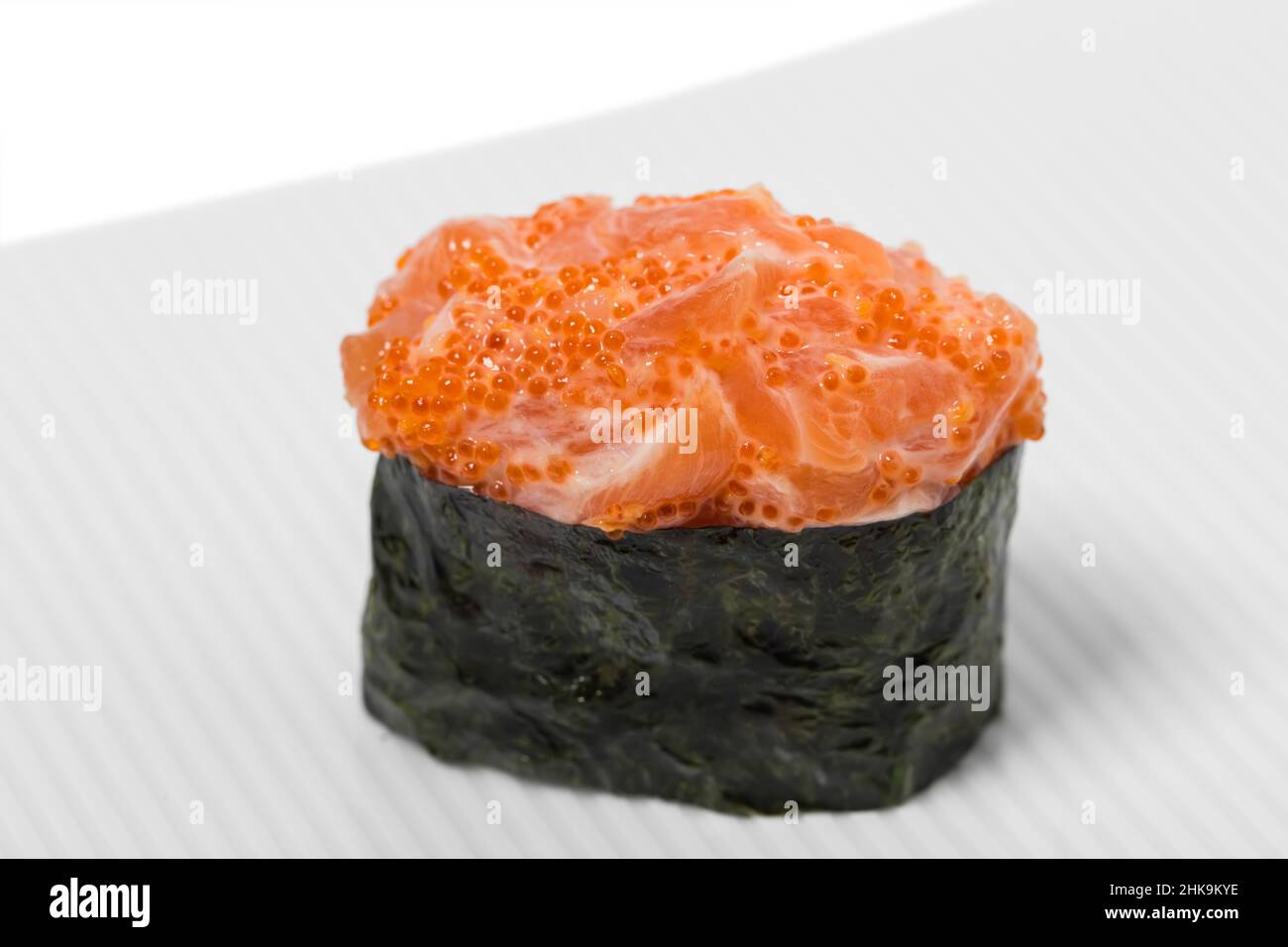 Gunkan sushi with salmon and red tobiko caviar. Isolated on a white ...