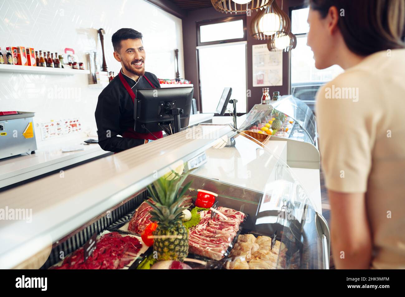 Female customer against raw meat stall section in food store Stock ...