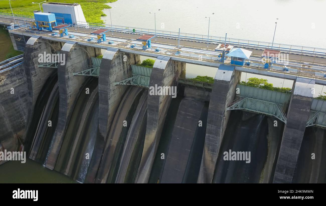 Hydroelectric dam with flowing water through gate, aerial view from ...