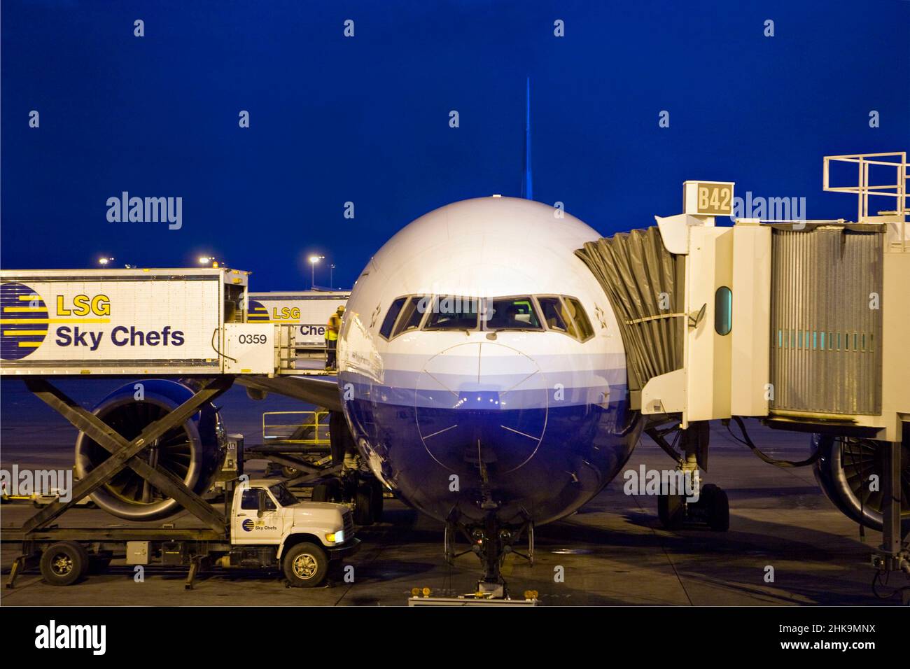 Passenger jet landing gate dusk H Stock Photo - Alamy
