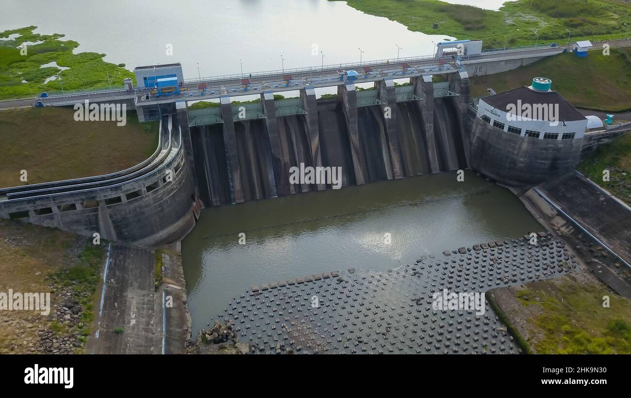 Hydroelectric dam with flowing water through gate, aerial view from ...